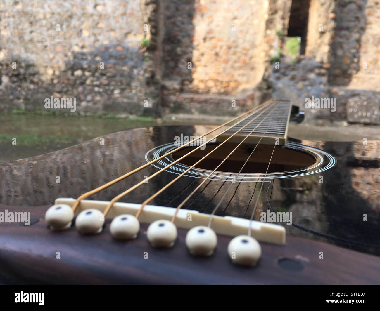 Guitar with wall Stock Photo - Alamy