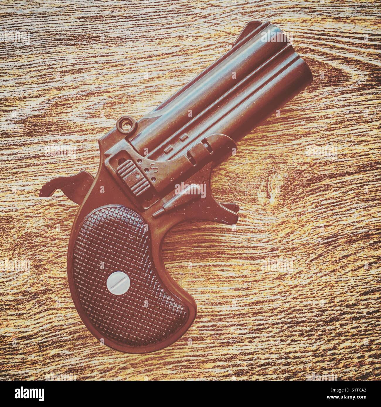 plastic gun toy on wood plastic Stock Photo - Alamy