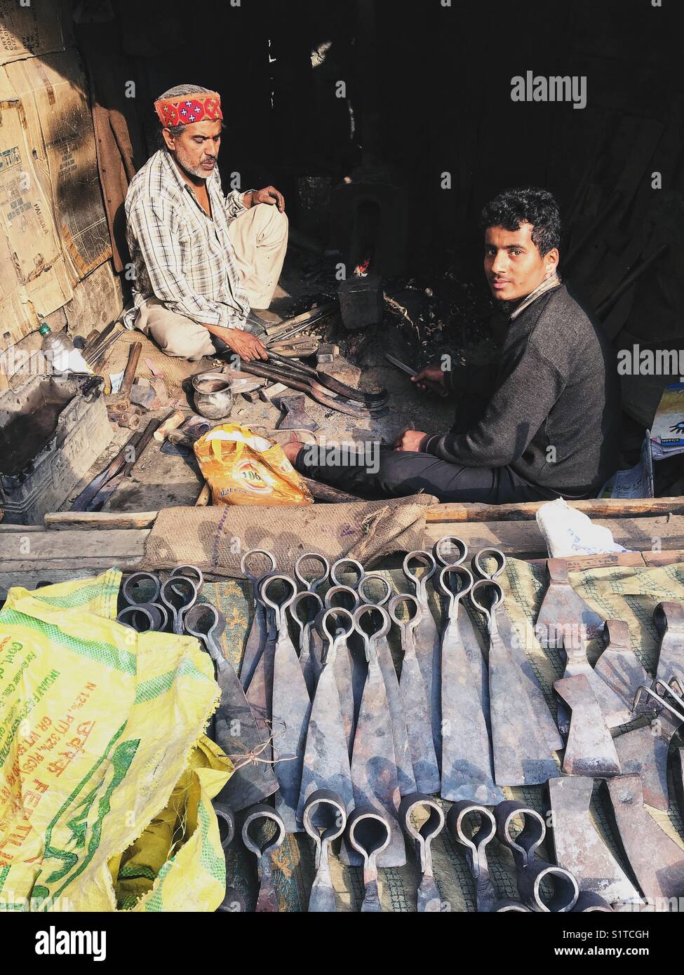A black smith forging basic tools for farming Stock Photo - Alamy