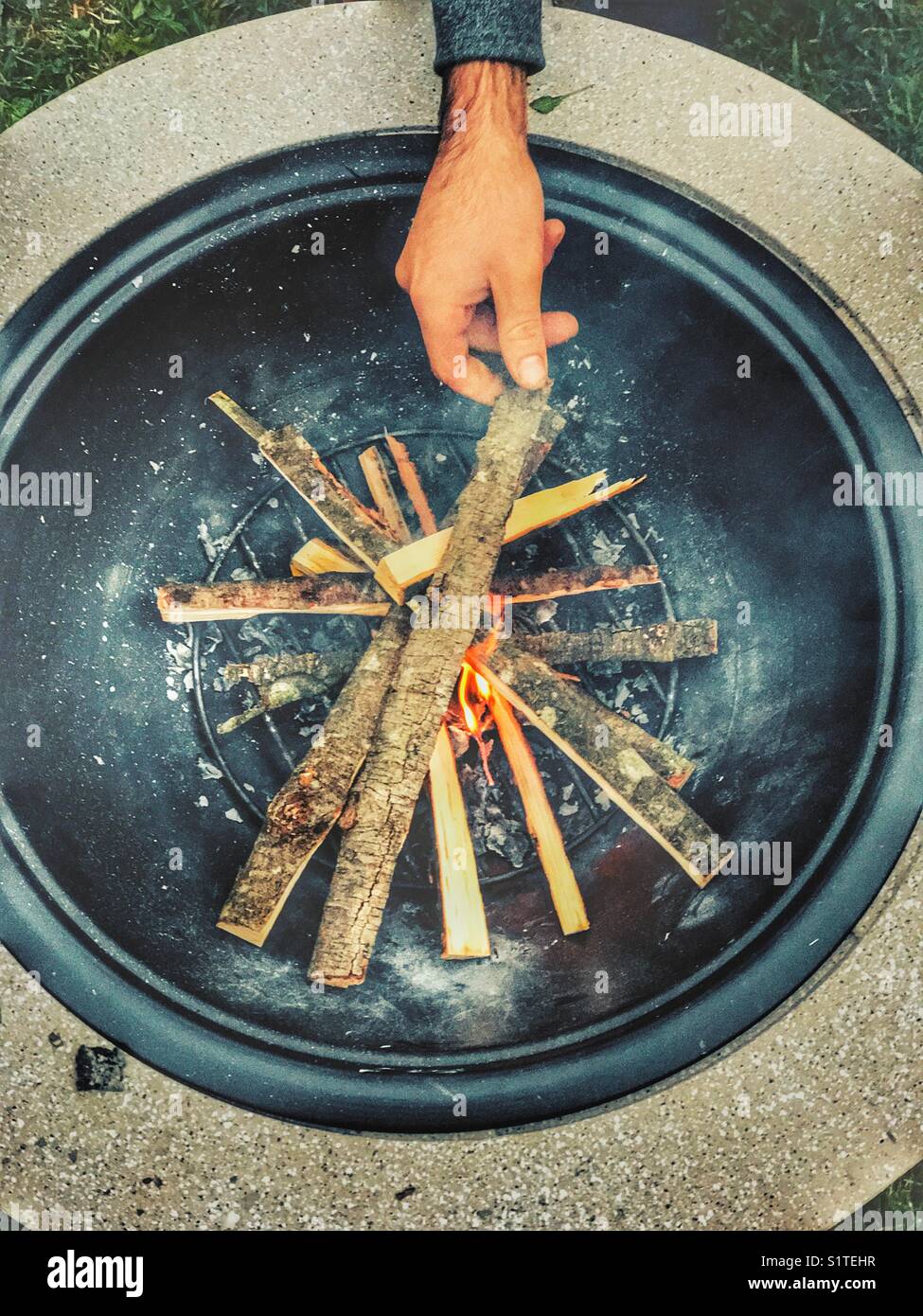 Preparing a fire place outdoors Stock Photo - Alamy