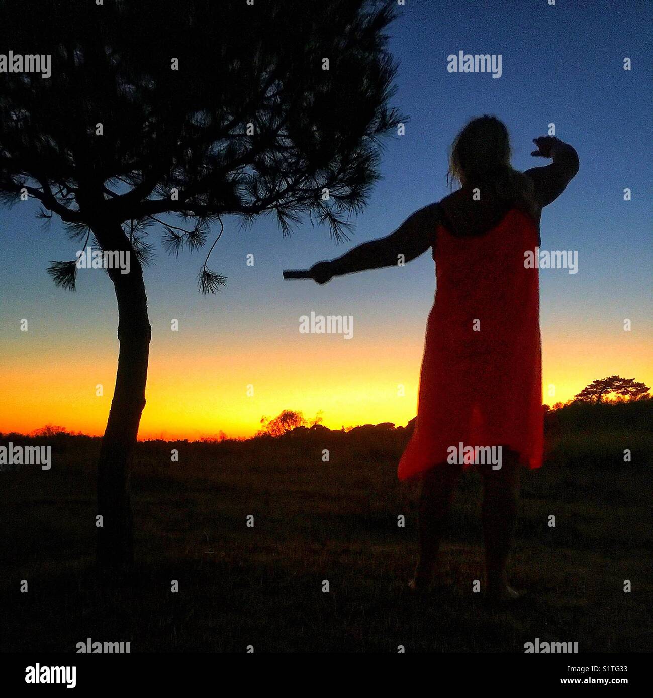 Woman dancing at sunset Stock Photo - Alamy