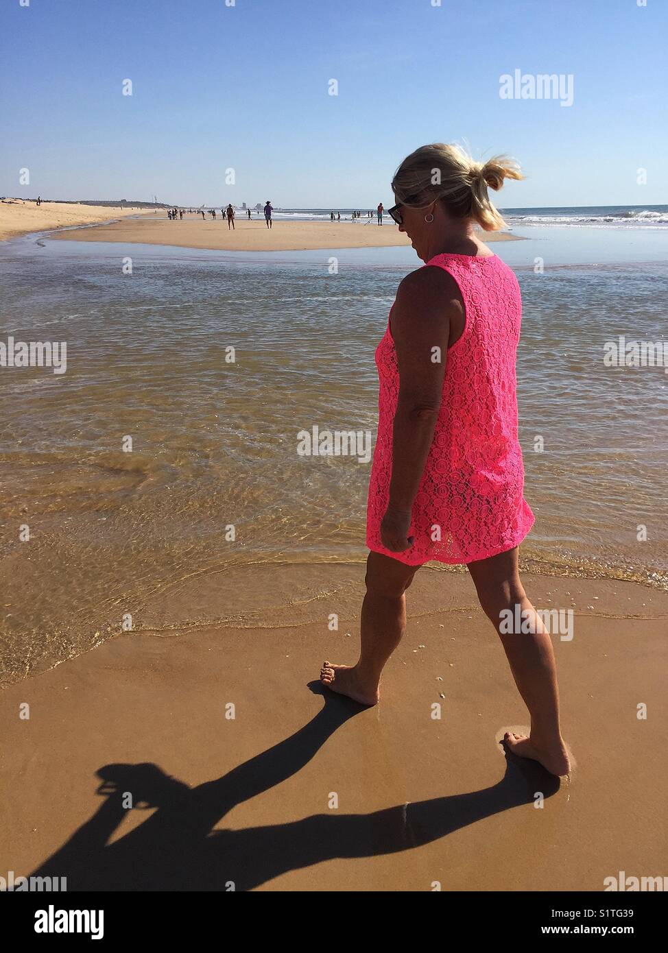 Woman in red dress beach hi-res stock photography and images - Alamy