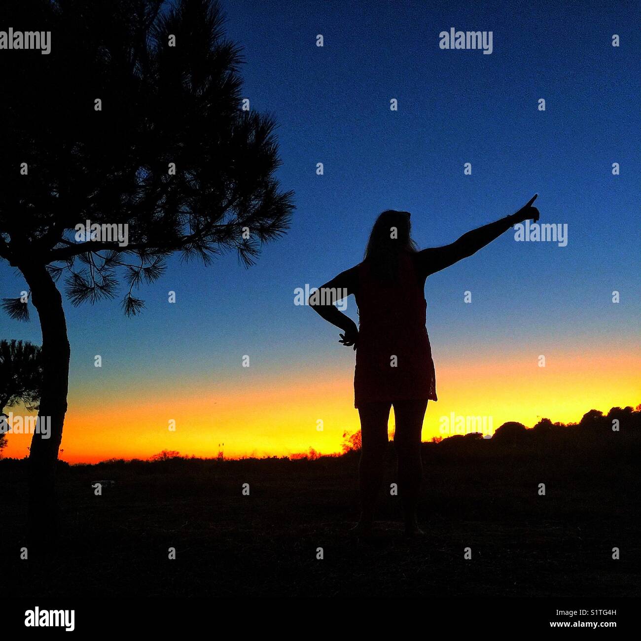 Woman dancing at sunset hi-res stock photography and images - Alamy