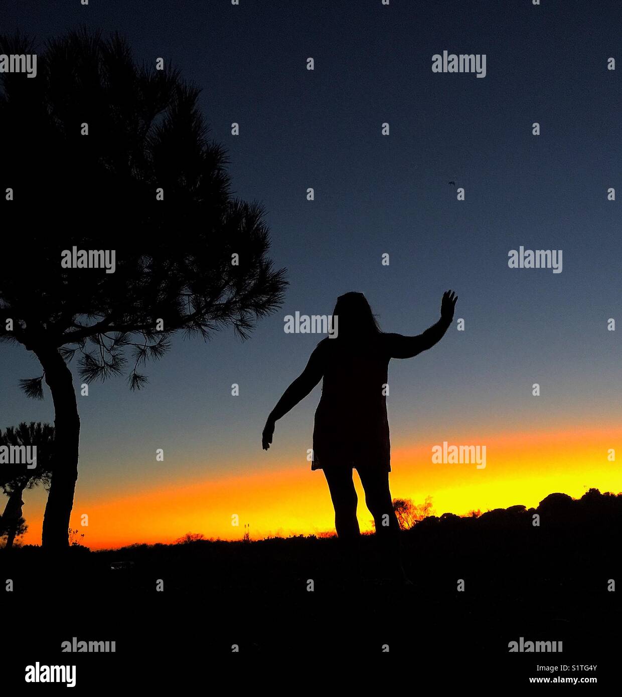 Woman dancing at sunset hi-res stock photography and images - Alamy