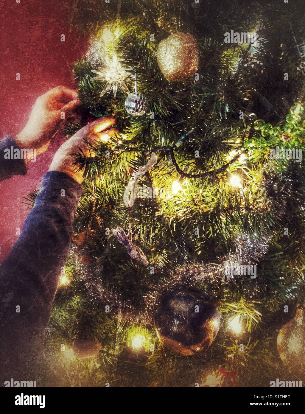Young hands decorating a Christmas tree Stock Photo - Alamy