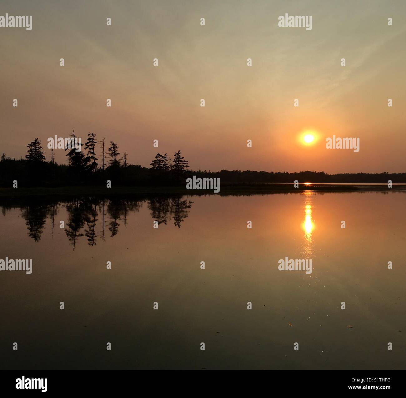 Mirror image sunset Stock Photo - Alamy