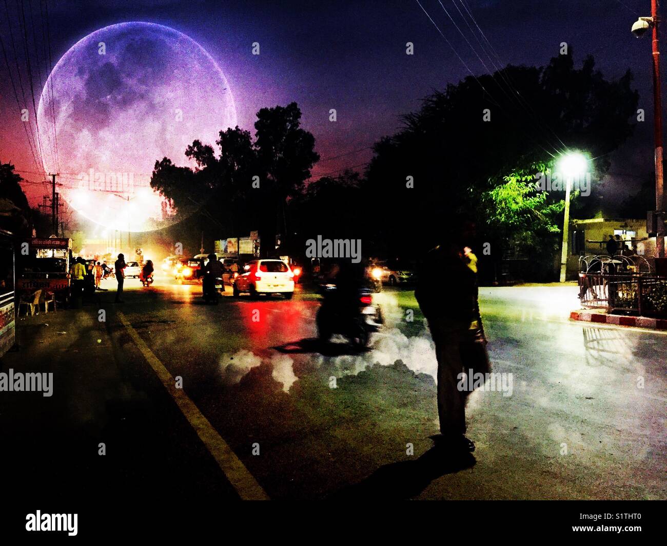 Street view with big moon Stock Photo - Alamy