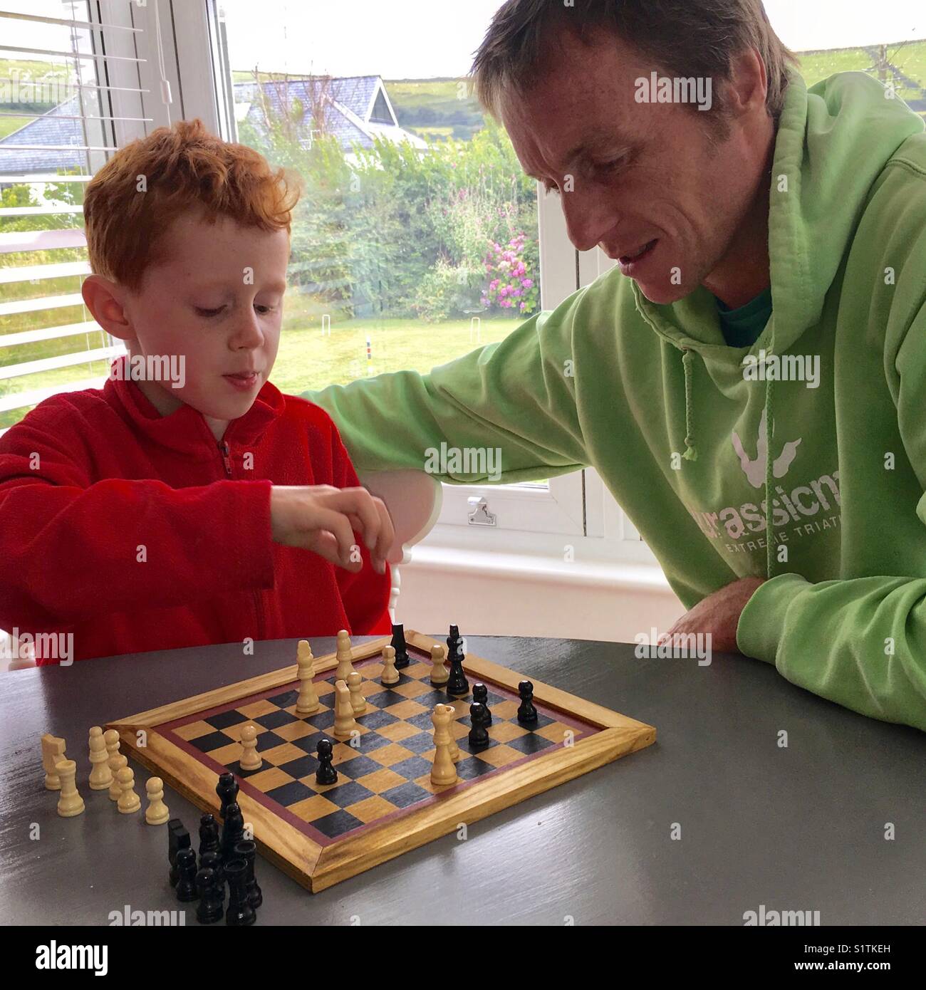 Father and son playing chess Stock Photo - Alamy