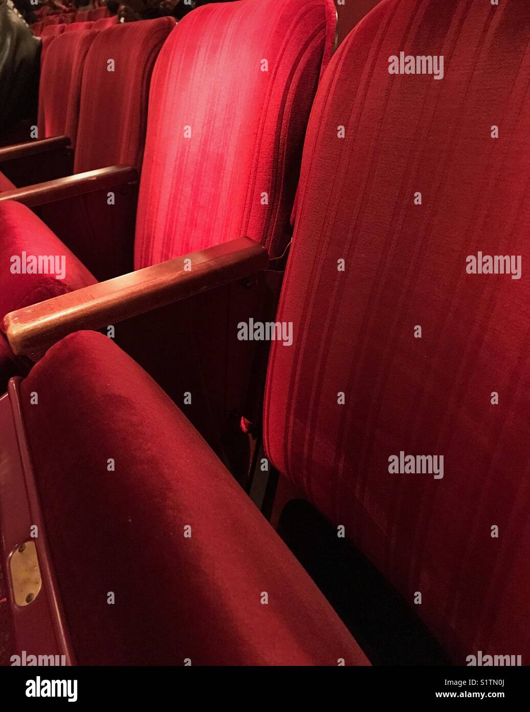 Red theatre seats up close Stock Photo - Alamy