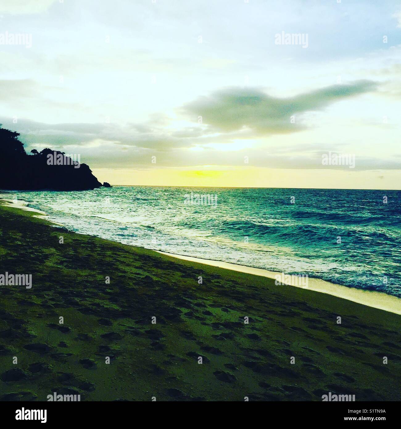 Sunset Puka Shell beach Stock Photo - Alamy