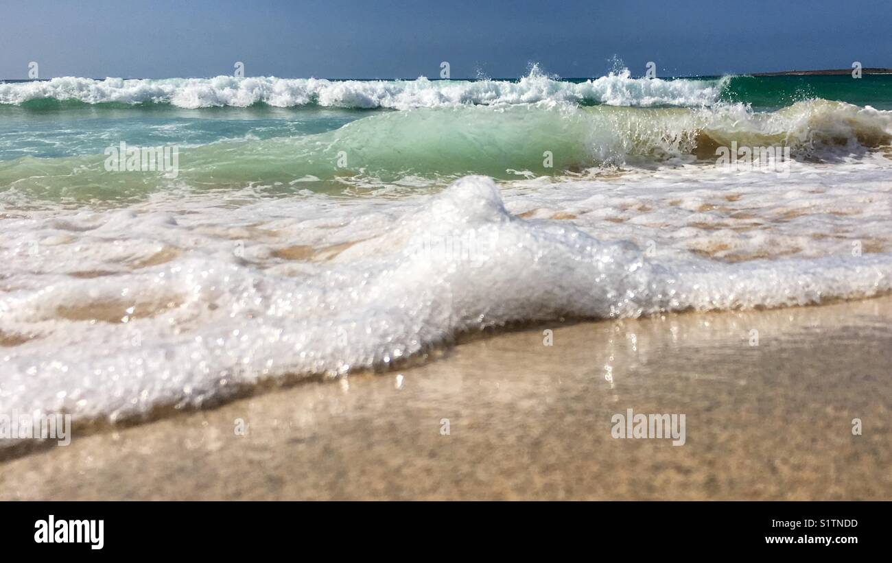 Incoming waves on sand beach Stock Photo - Alamy