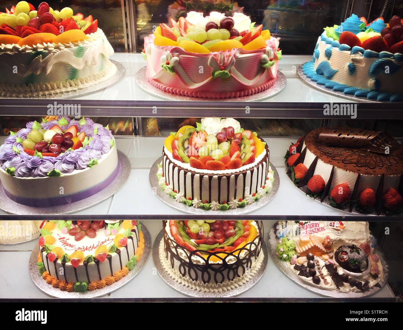 A selection of birthday cakes are seen on display in the window of a ...