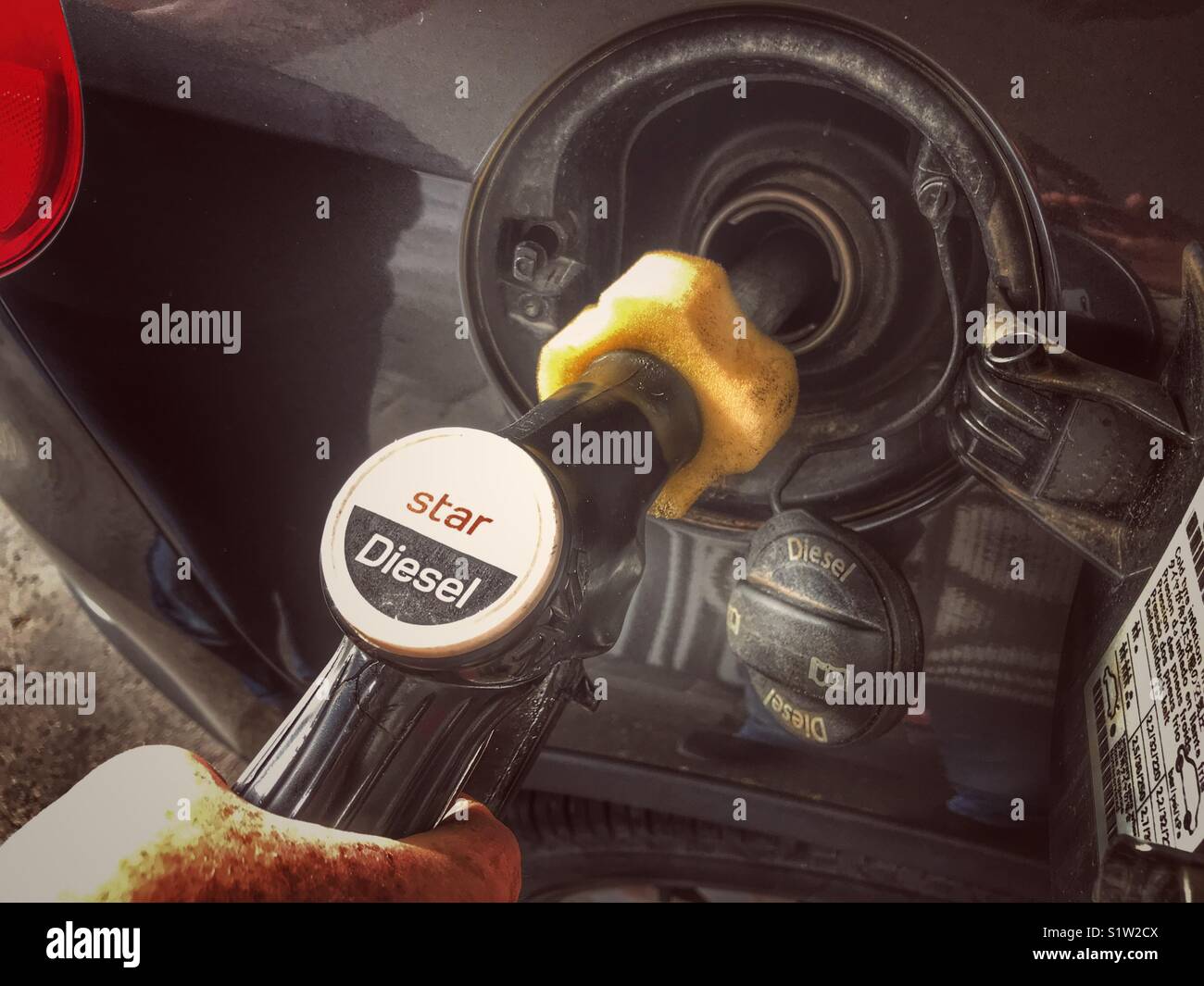 Filling car with diesel from the pump at a fuel station Stock Photo - Alamy