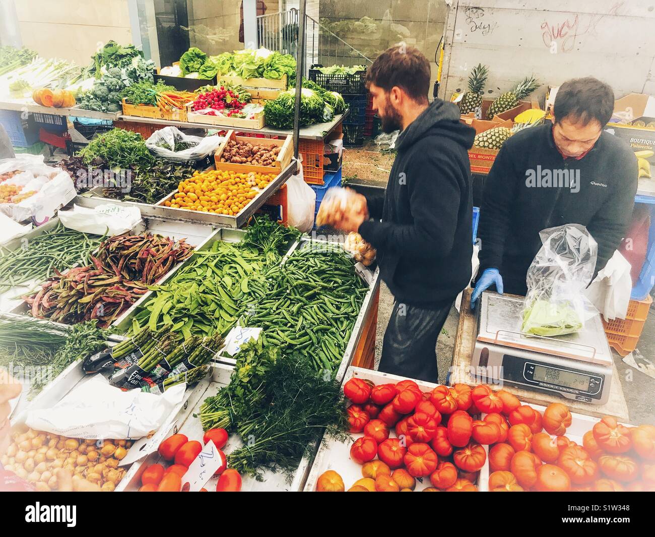 Vendors selling vegetables on a market stall at the Thursday market in ...