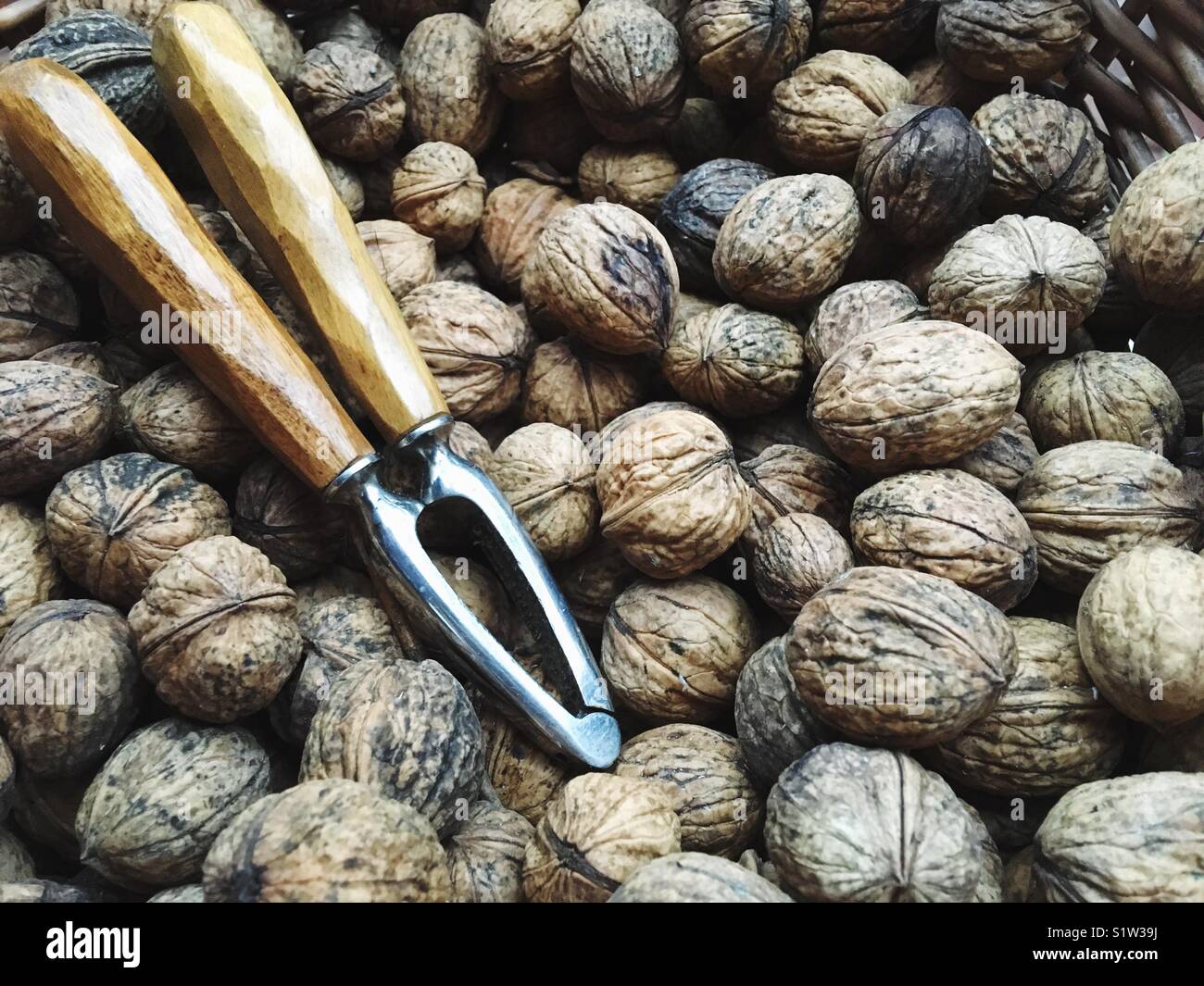 Walnuts and a nut cracker Stock Photo - Alamy