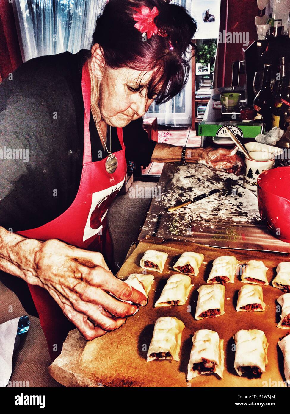 Elderly woman making sausage rolls Stock Photo - Alamy