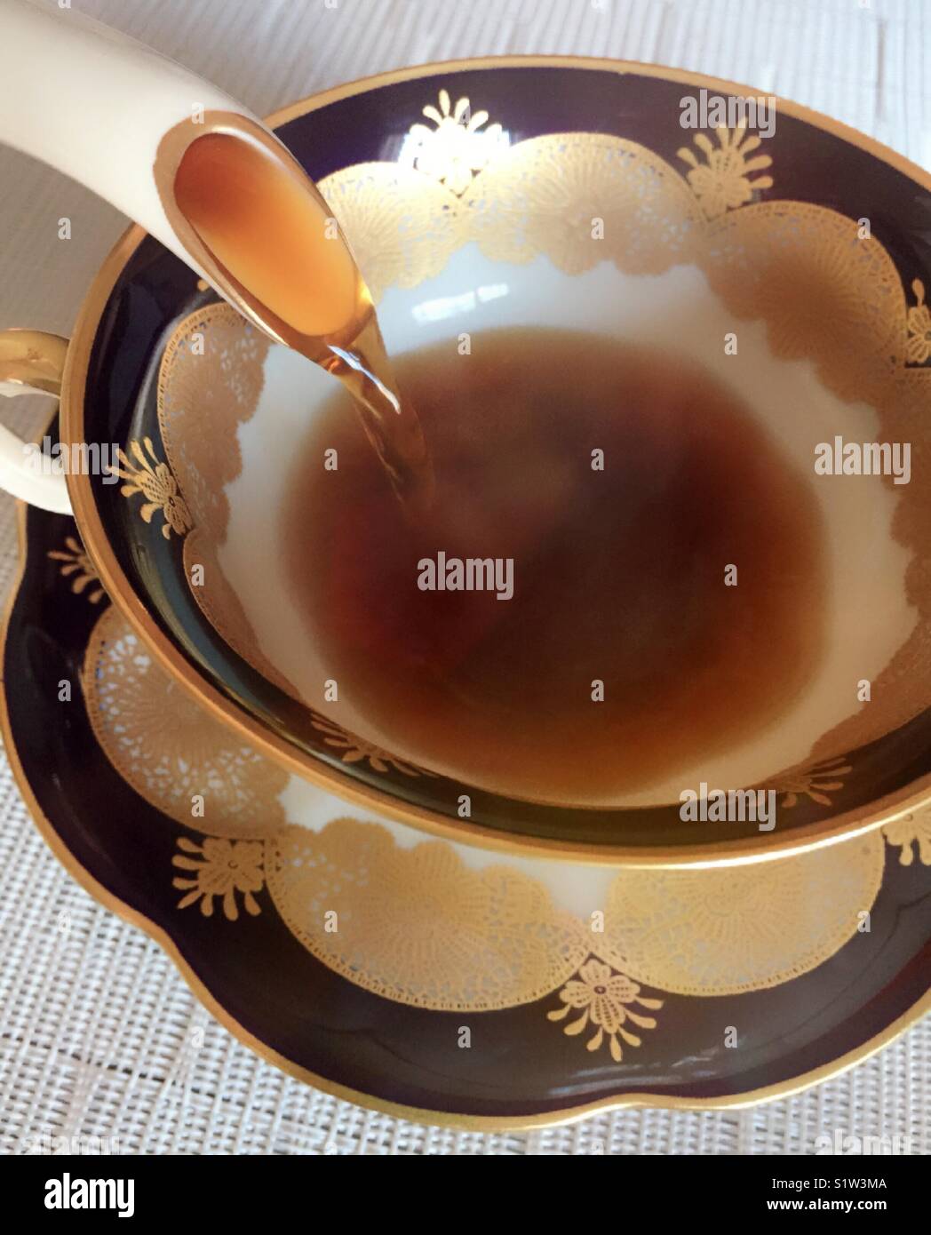 Coffee being poured from a China coffee pot into a china cup Stock ...