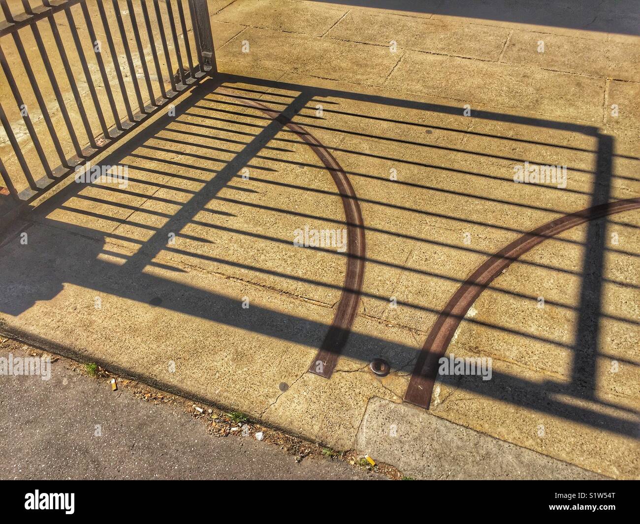 Shadow of a gate Stock Photo - Alamy