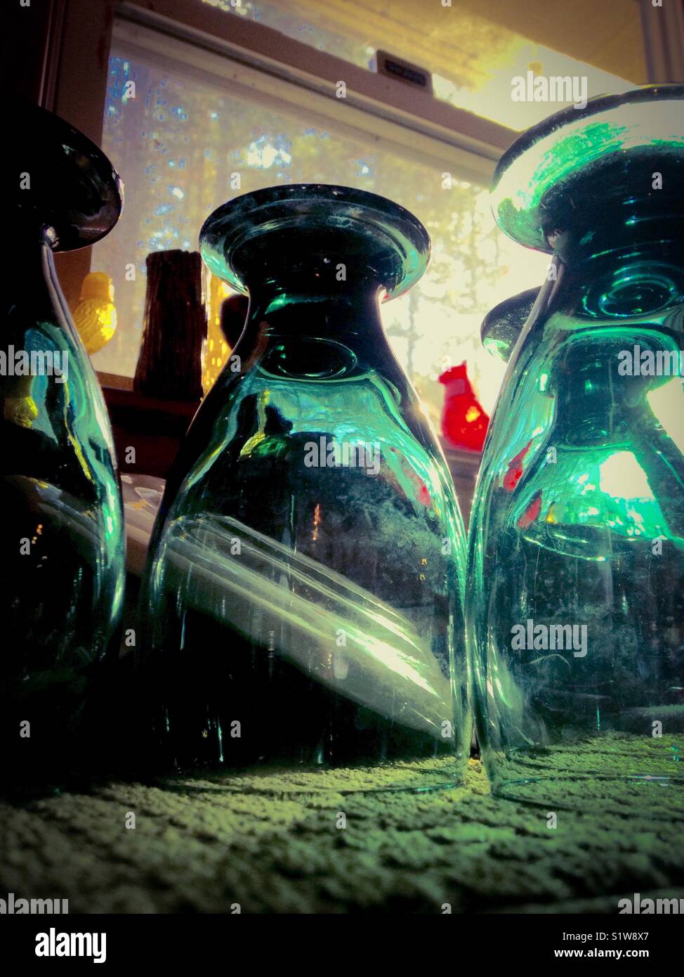 Colored dishes drying in window light Stock Photo - Alamy