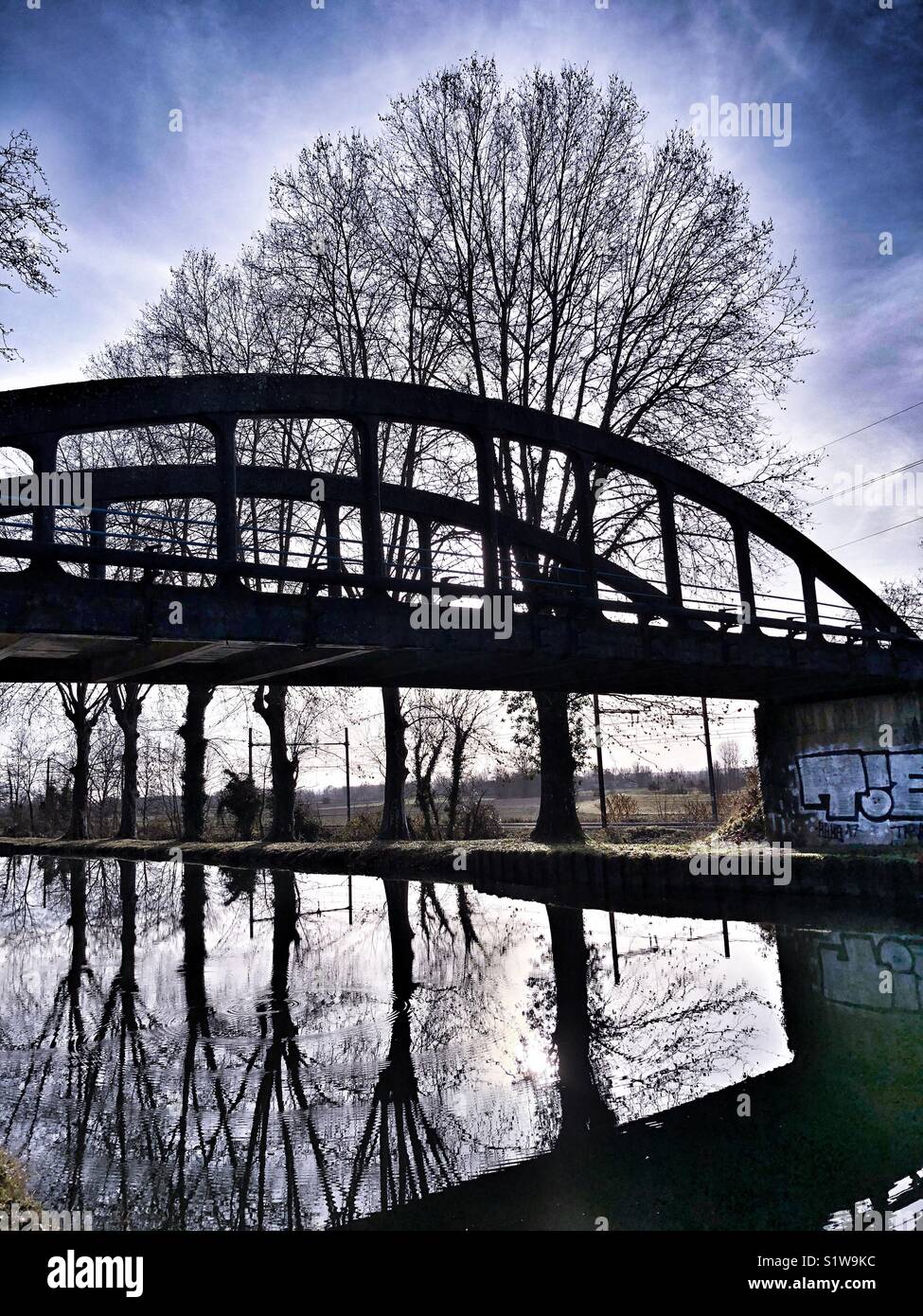 Arched road bridge over a French canal Stock Photo - Alamy