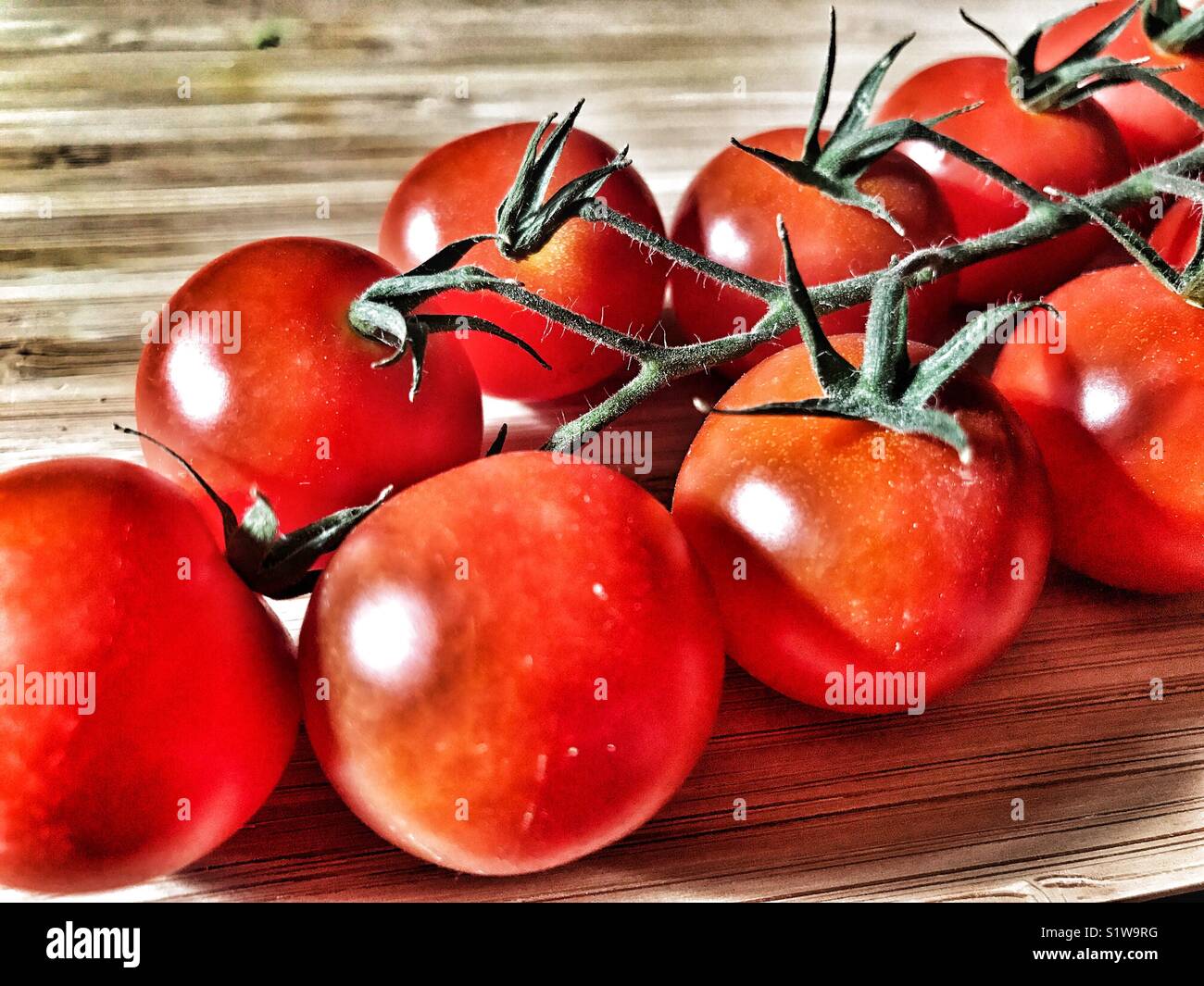 Cherry vine tomatoes Stock Photo - Alamy