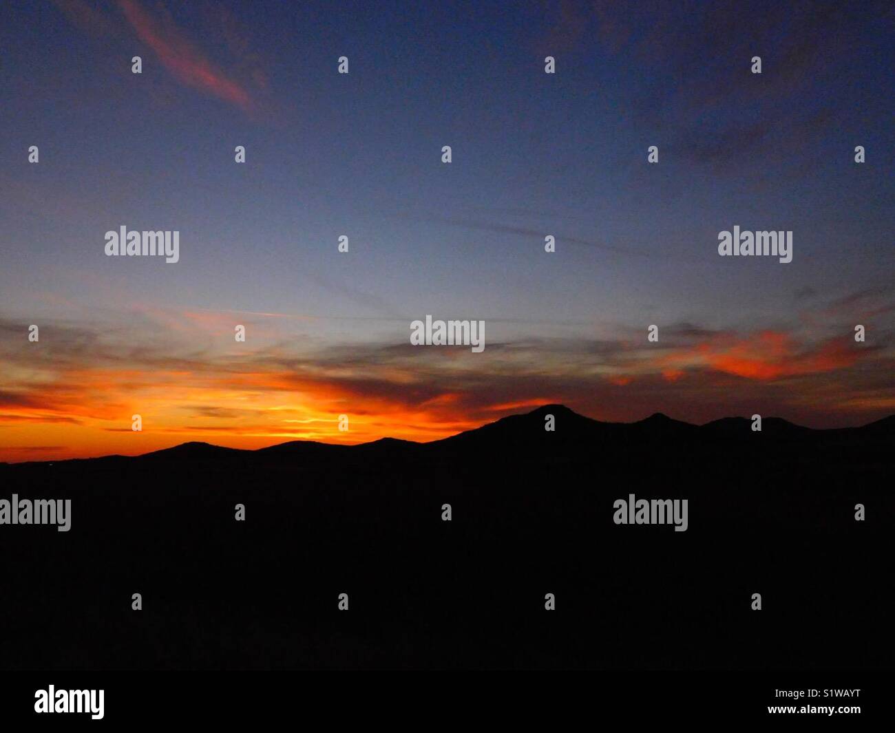 Sun setting behind the Wichita Mountains Stock Photo - Alamy