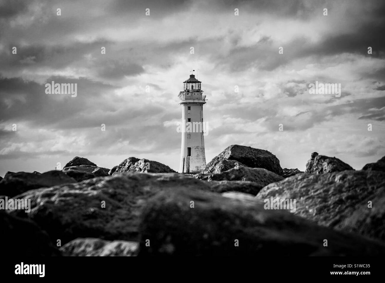 Lighthouse on the rocks Stock Photo - Alamy