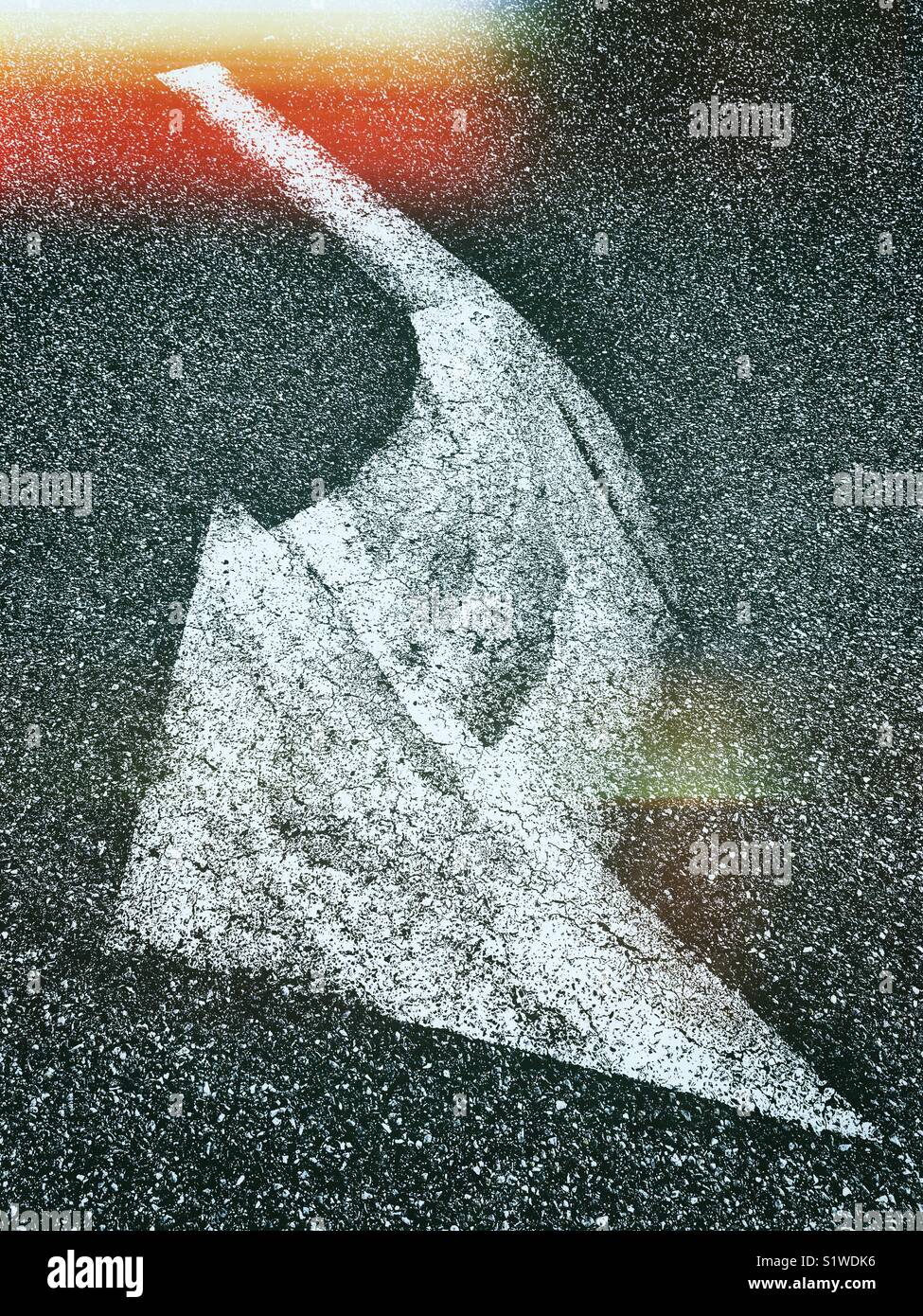 Directional arrow painted on the road Stock Photo - Alamy