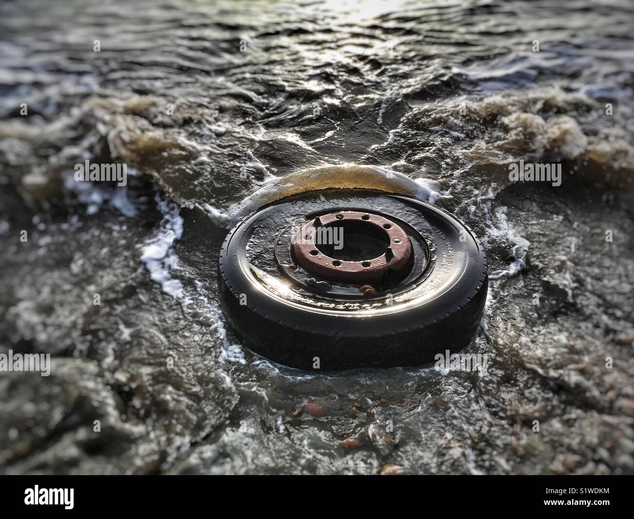 Lorry wheel from a sunken cargo ferry washed up on the beach, Bawdsey ...
