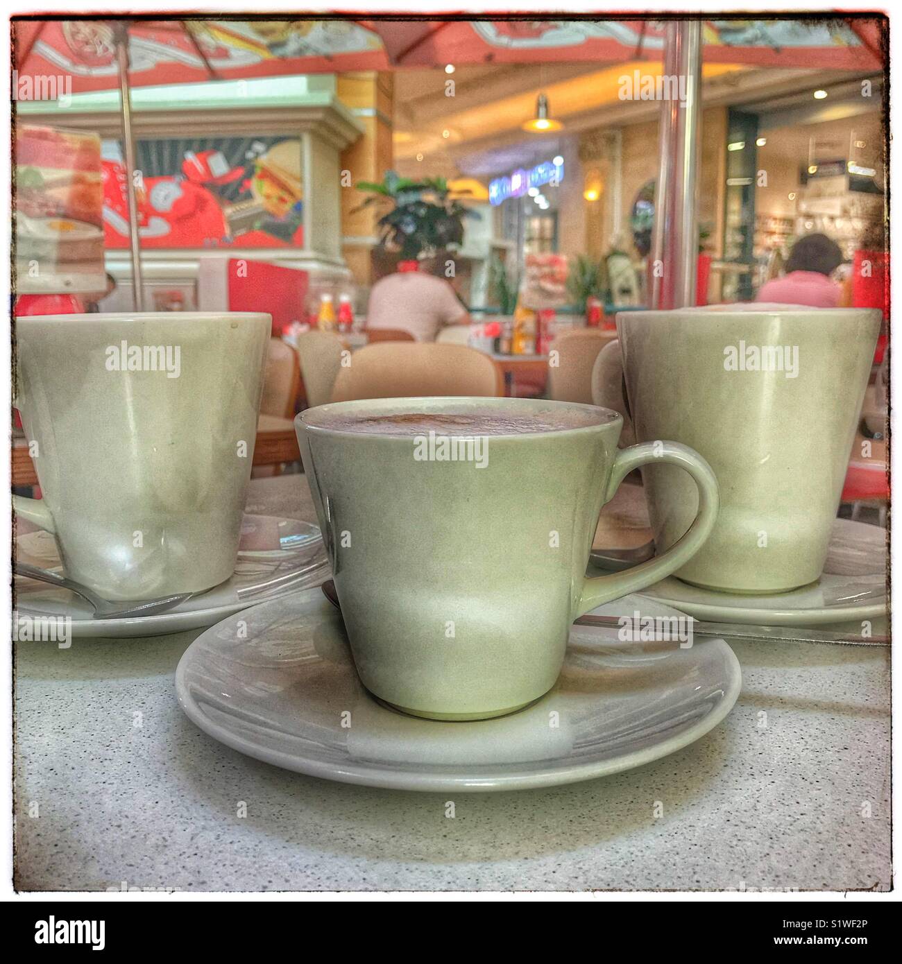 Three cups of coffee on restaurant table Stock Photo - Alamy