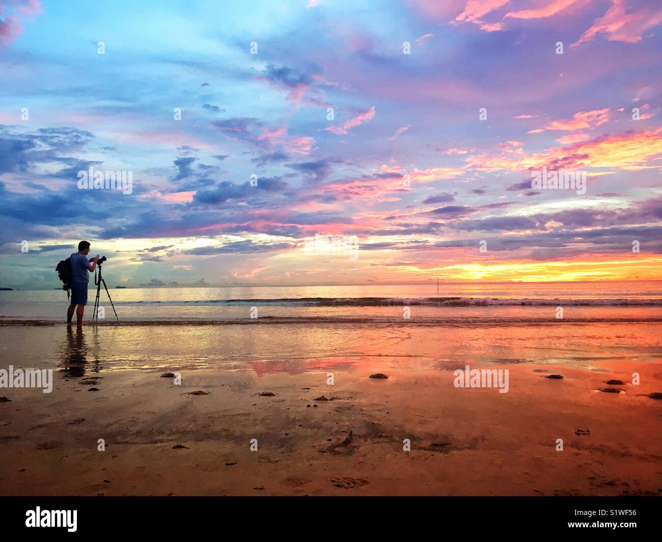 Photographer capturing sunset Stock Photo - Alamy