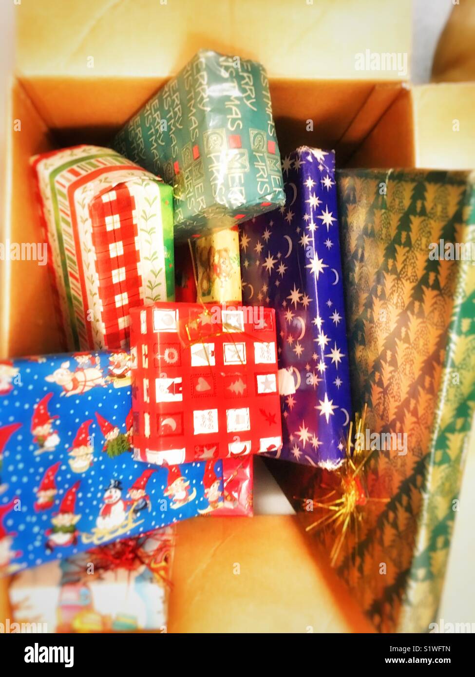 Christmas presents in a cardboard box Stock Photo - Alamy