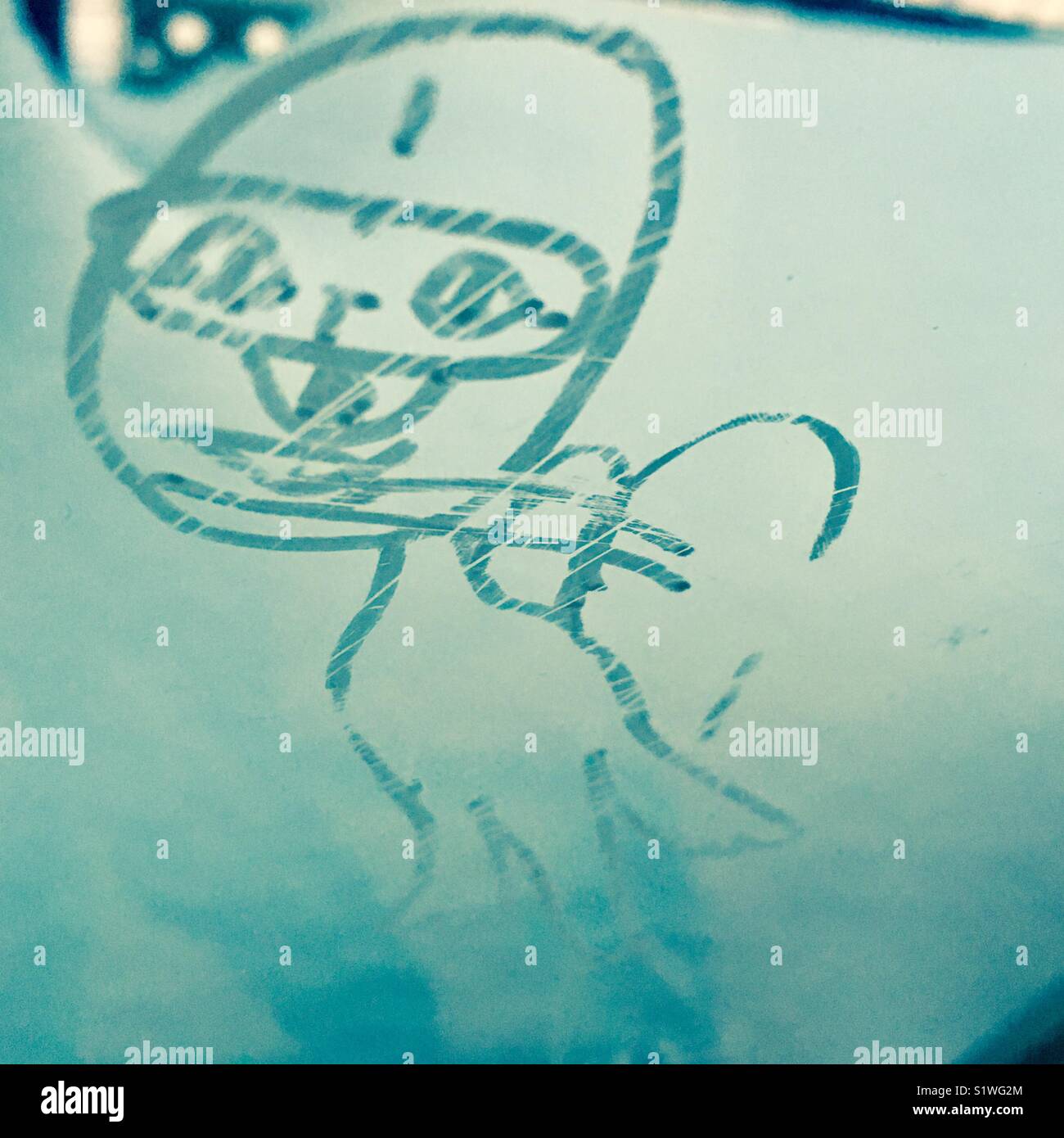 Drawing on frosted window Stock Photo - Alamy