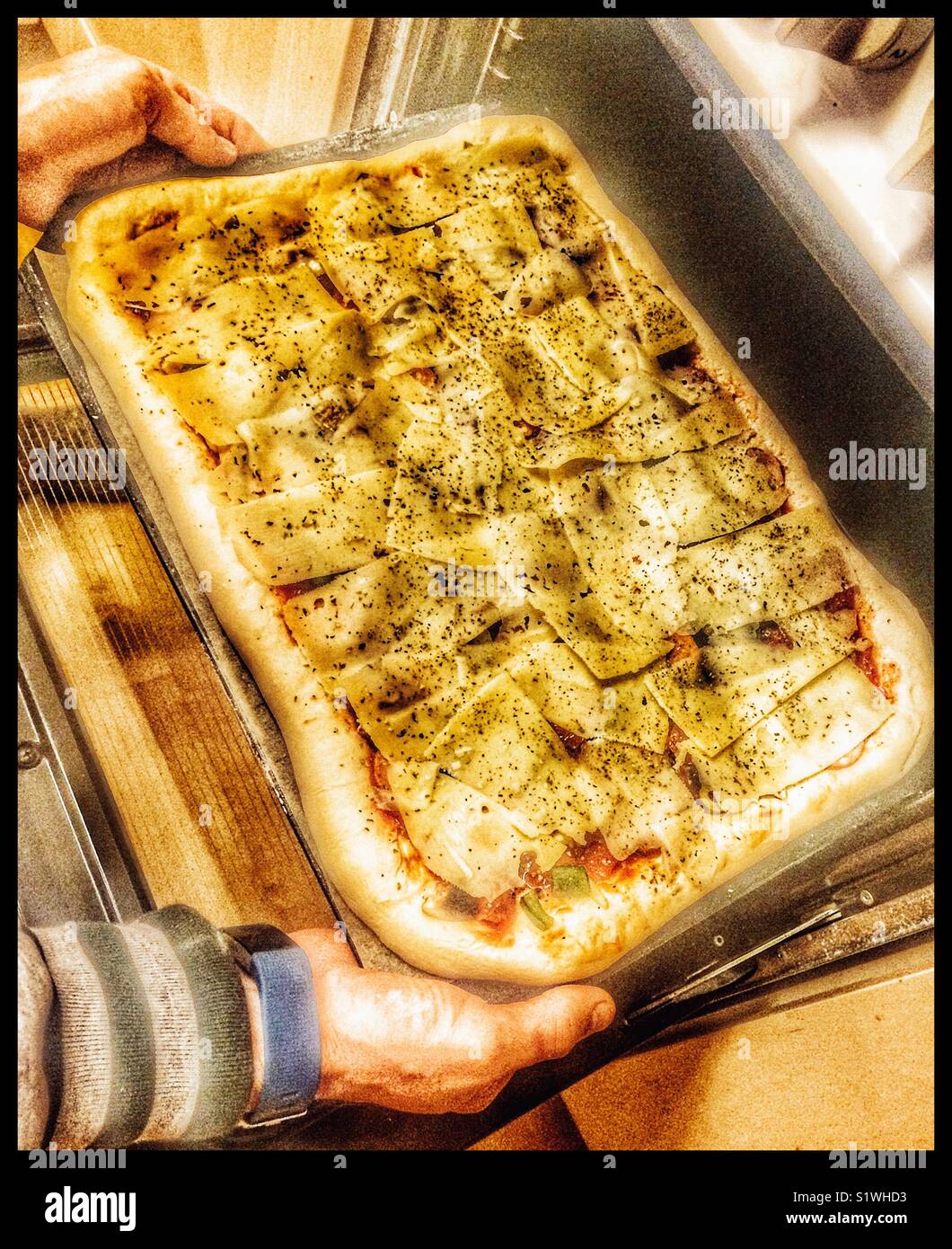 Man putting homemade pizza into the oven Stock Photo - Alamy