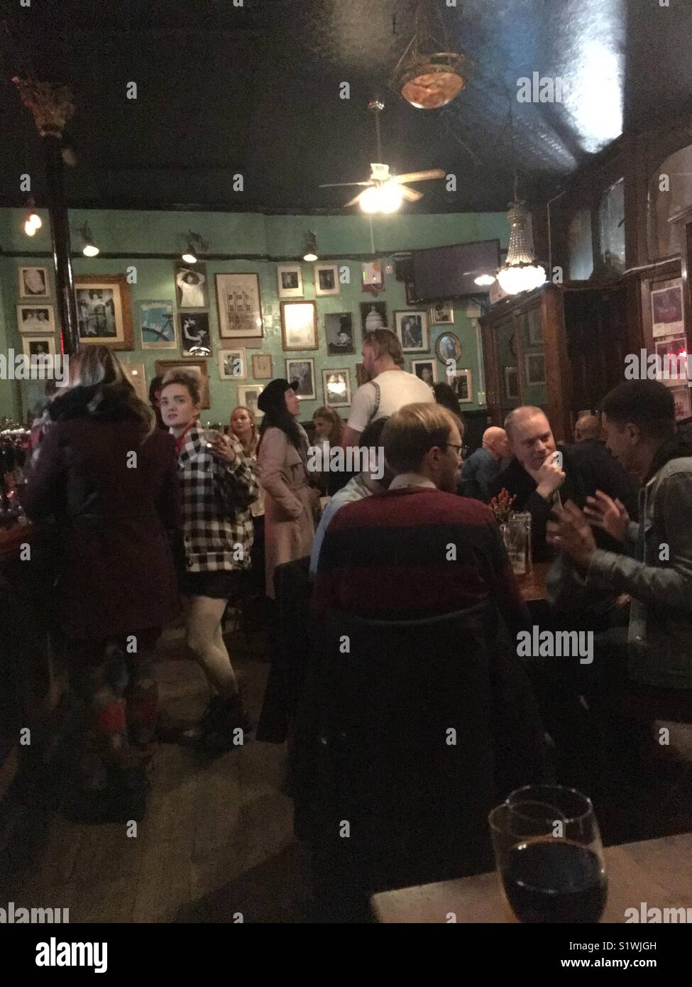 Night at the pub. Punters waiting for service at the Kings Head Theatre ...