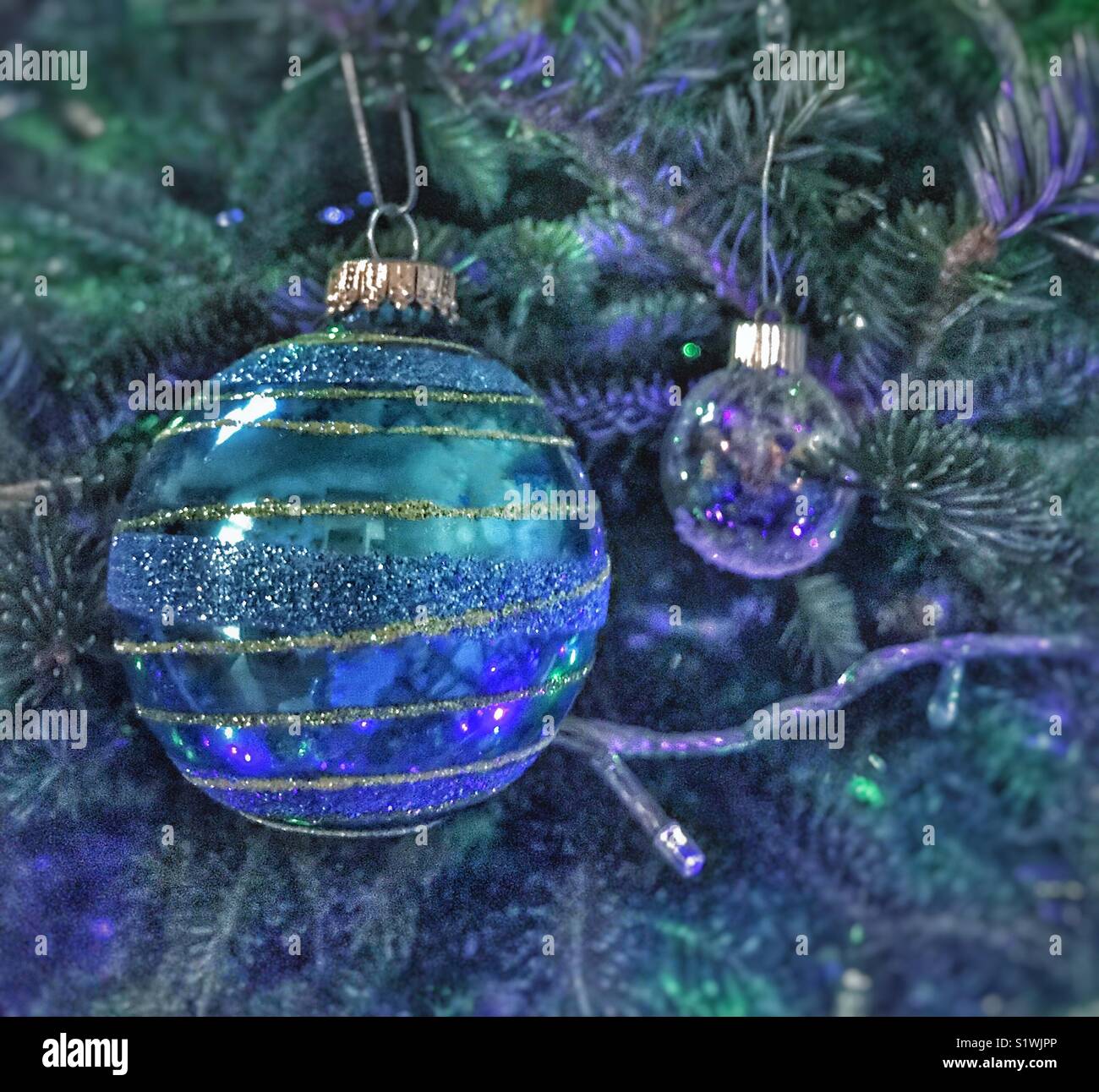 Fancy Christmas baubles hanging on the tree Stock Photo - Alamy