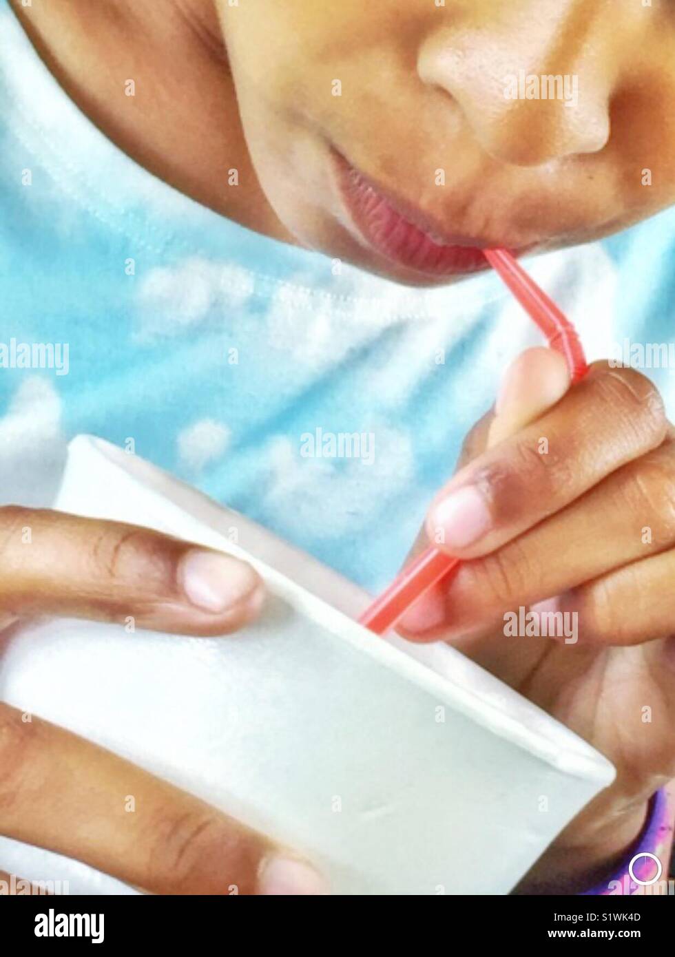 Child drinking through a straw Stock Photo - Alamy