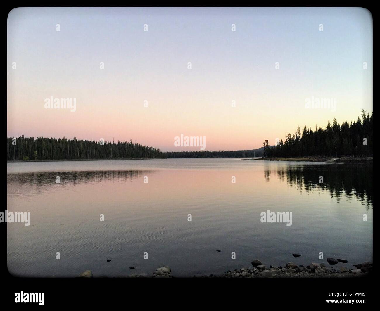 Subtle sunrise at a lake Stock Photo - Alamy
