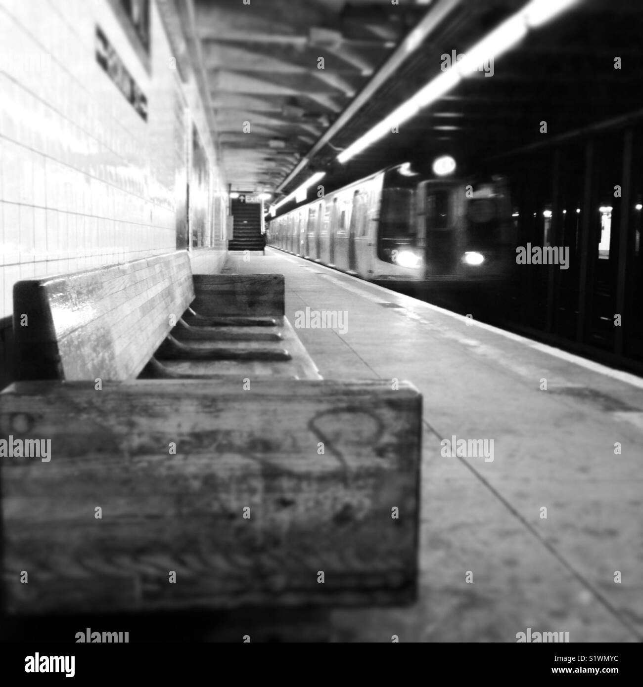 Train station bench Stock Photo - Alamy
