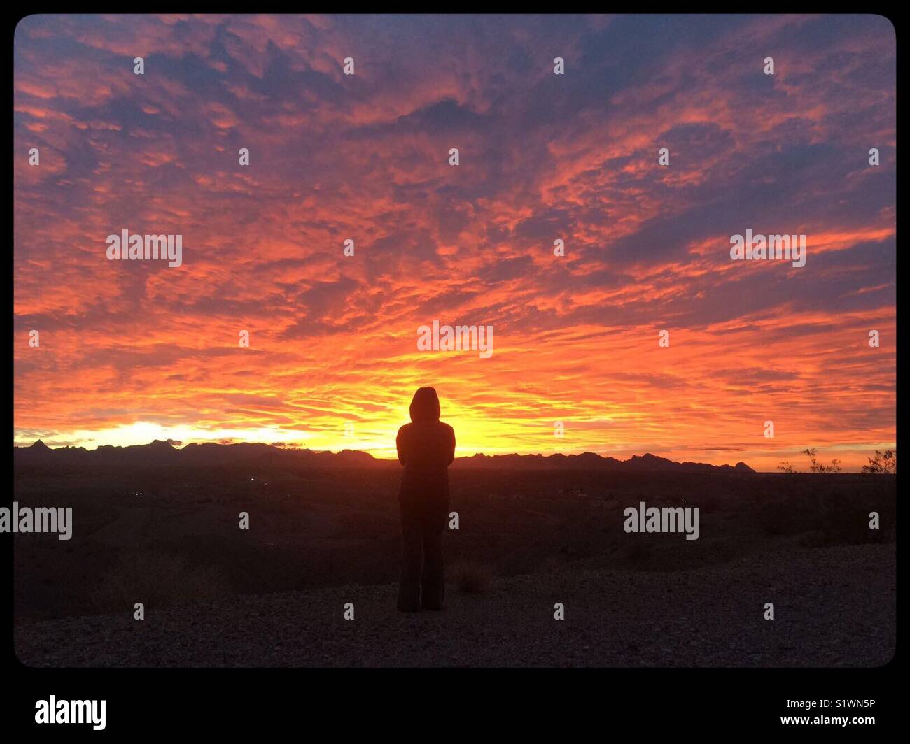 Spectacular sunrise with woman in the shadow Stock Photo - Alamy