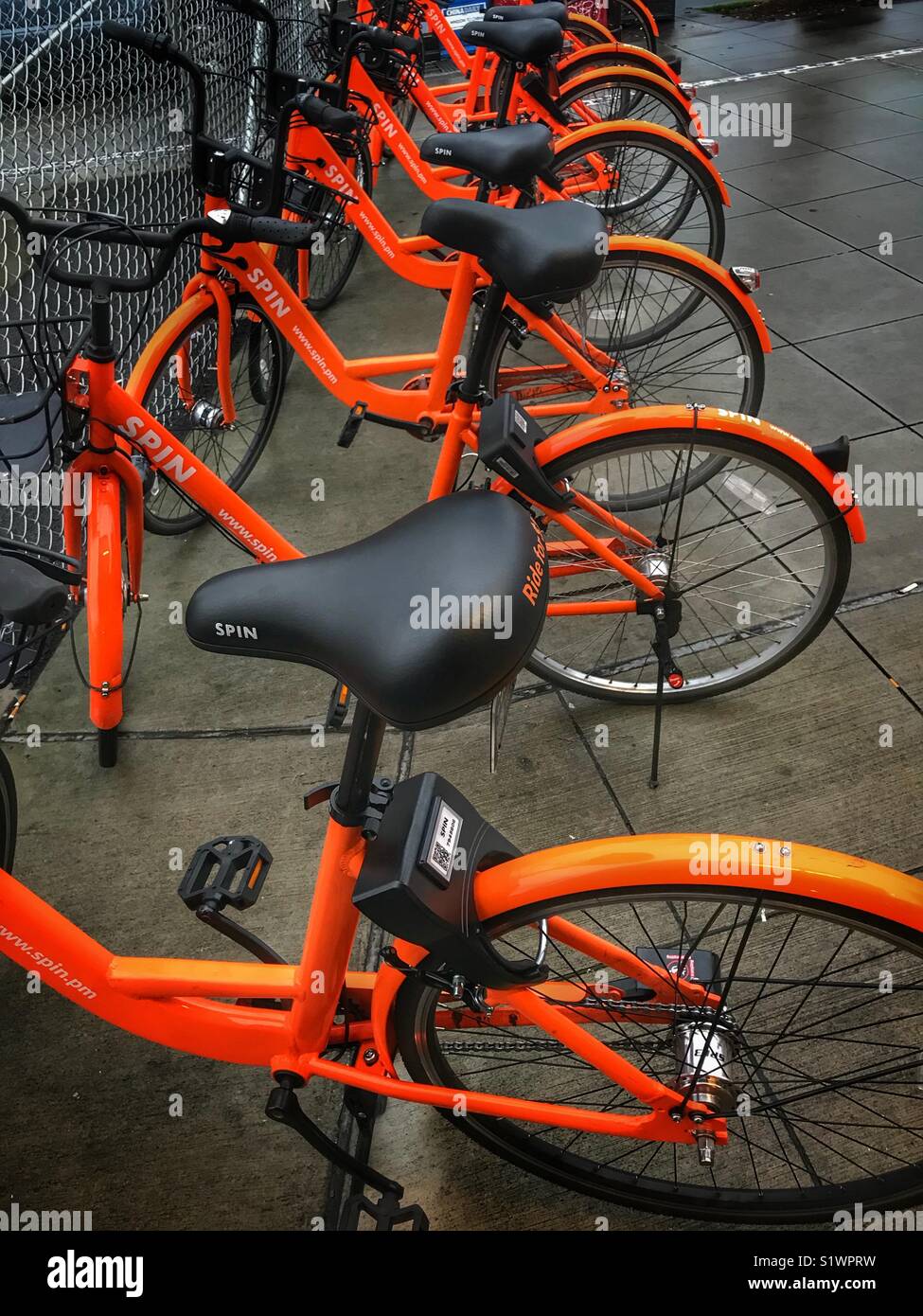 Bikes for rent lined up at the fence by the train station in Capital ...