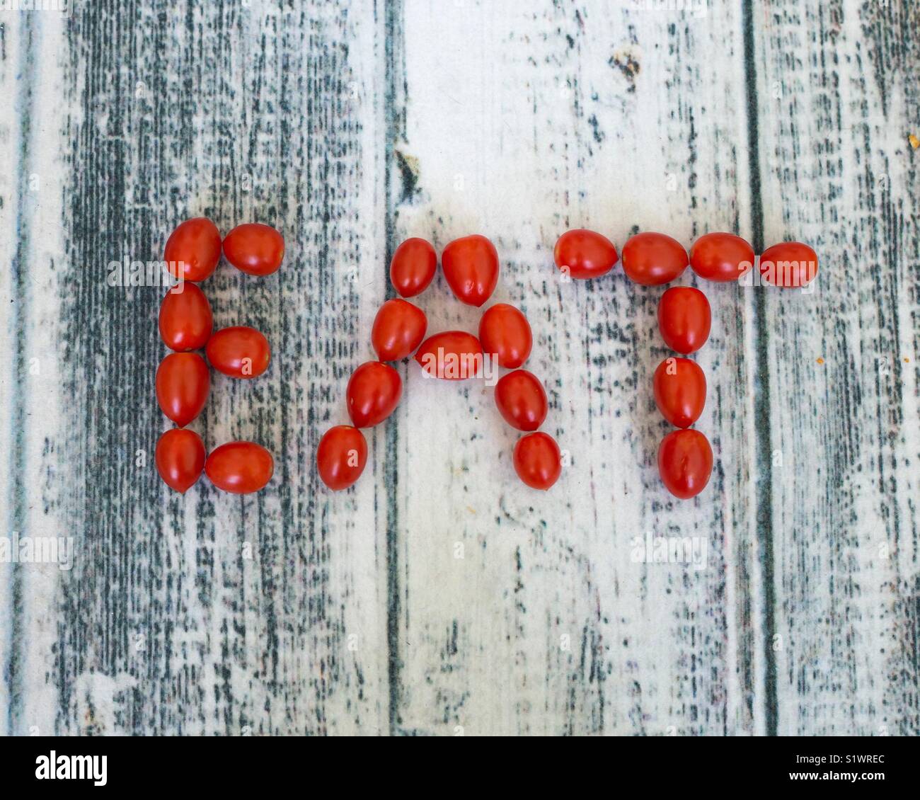 EAT word art with tomatoes Stock Photo - Alamy