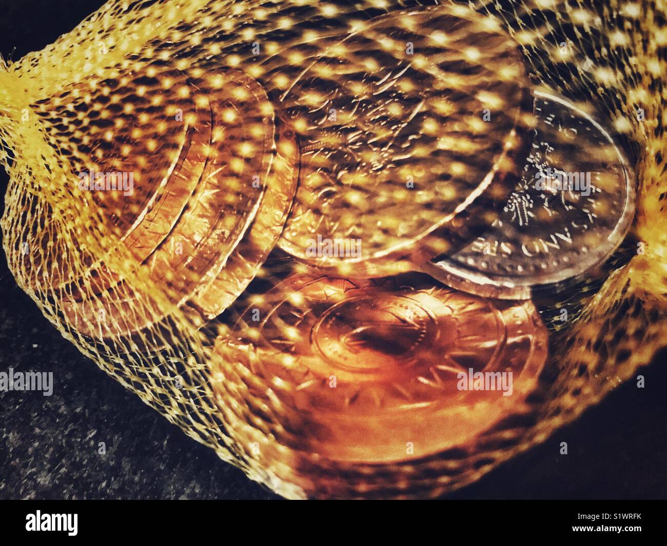 Chocolate money in a plastic net bag Stock Photo - Alamy