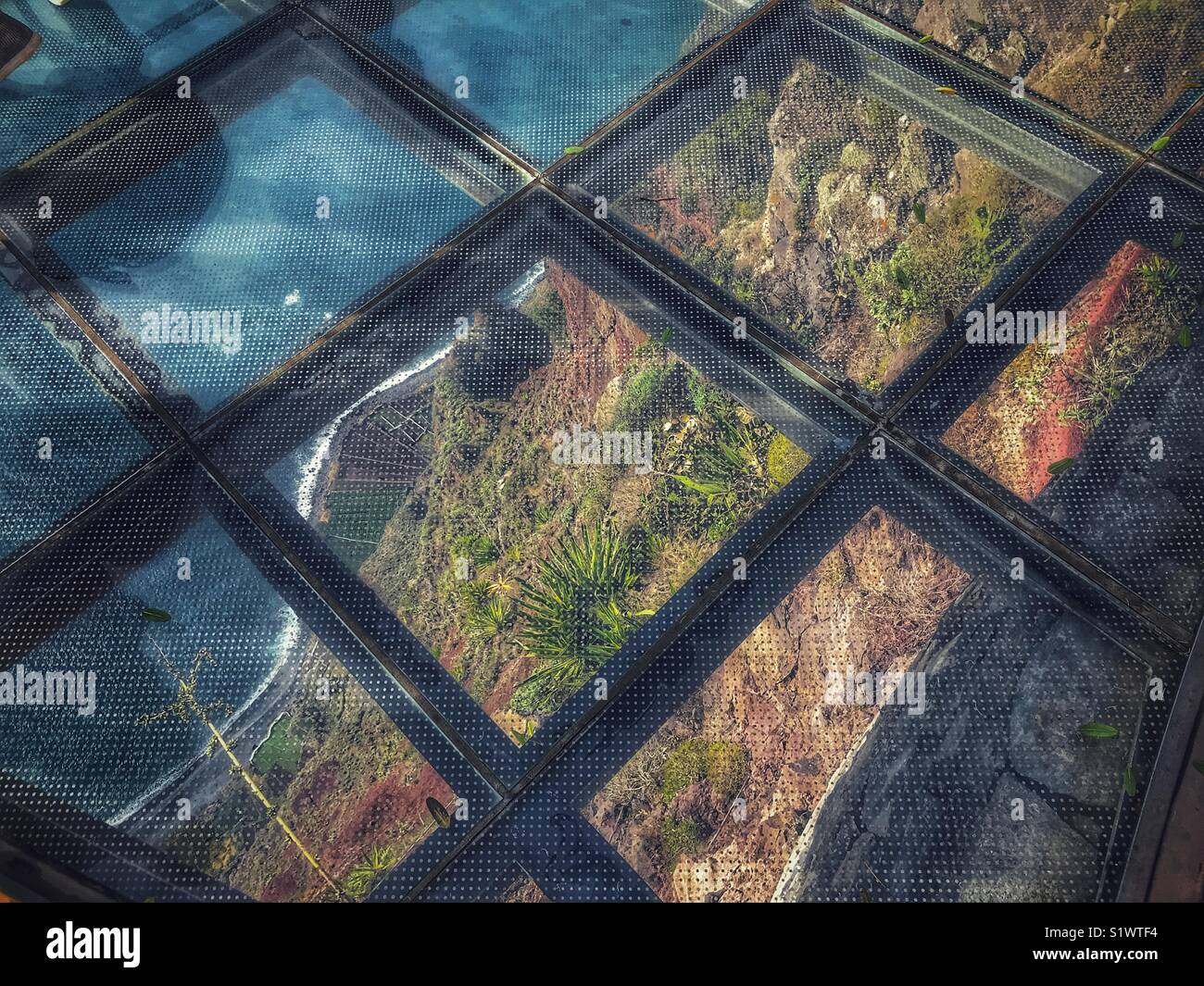 Looking through the glass skywalk viewing platform 580m above the sea ...