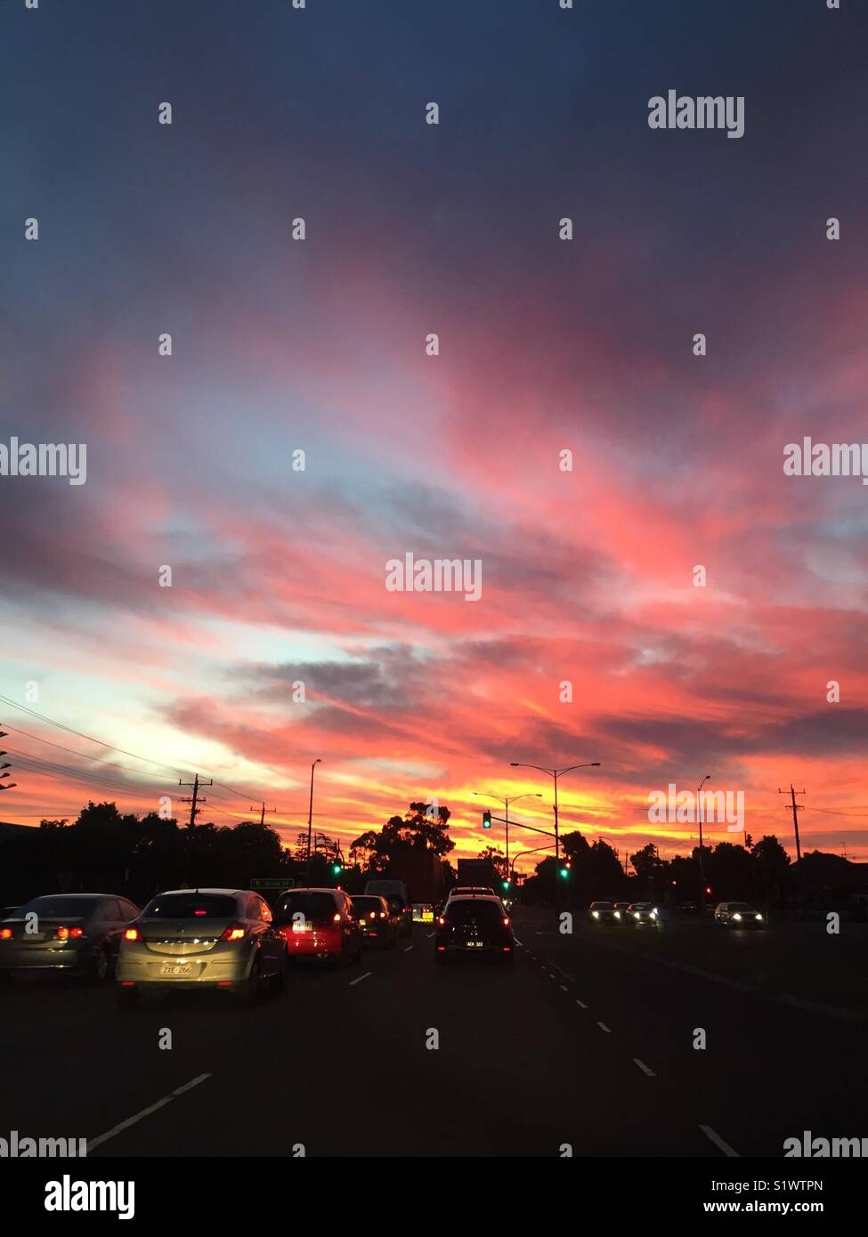Cars driving into the sunset Stock Photo - Alamy