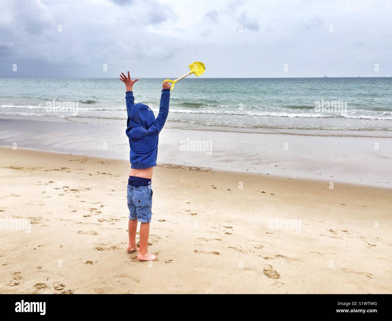 Child Raising Arms on Beach Stock Photo - Alamy