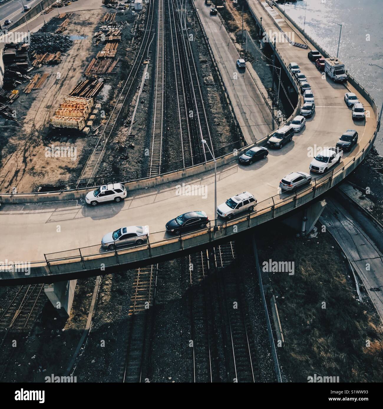 Cars parked on a curve over train tracks Stock Photo - Alamy