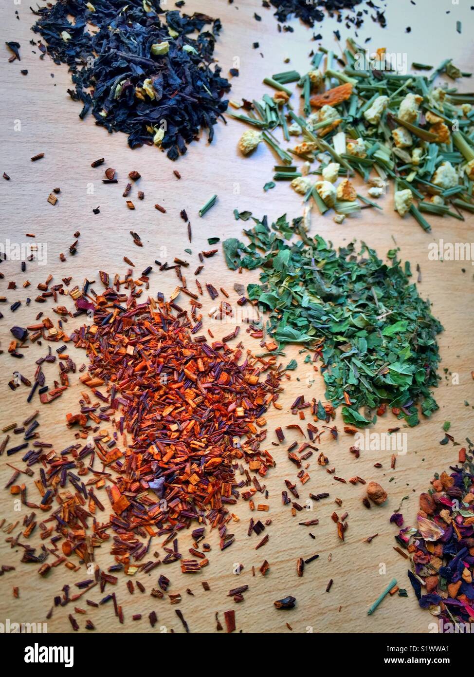 Piles of various flavored herbal loose teas Stock Photo - Alamy