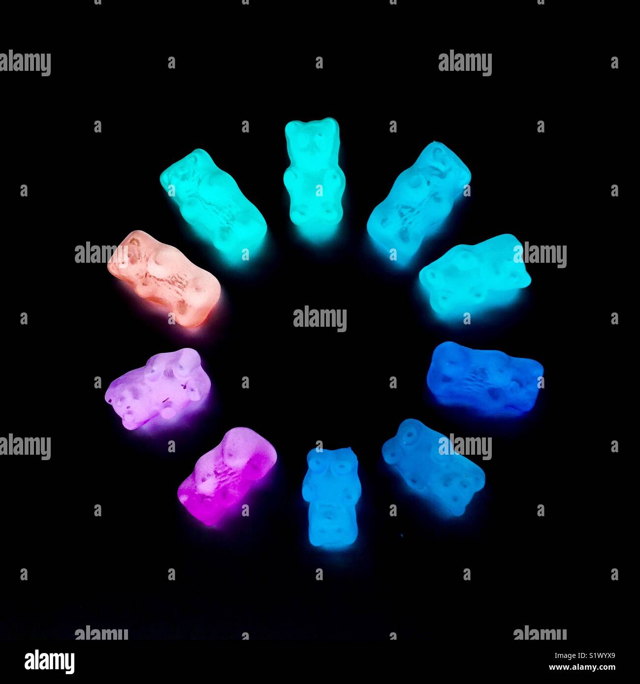 Gummy bear candy glowing in the dark Stock Photo - Alamy