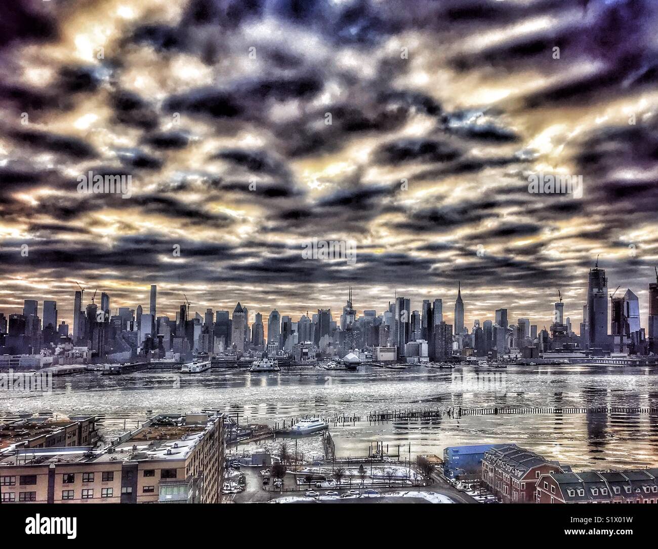 Orange sky New York City skylines with iced Hudson River Stock Photo ...